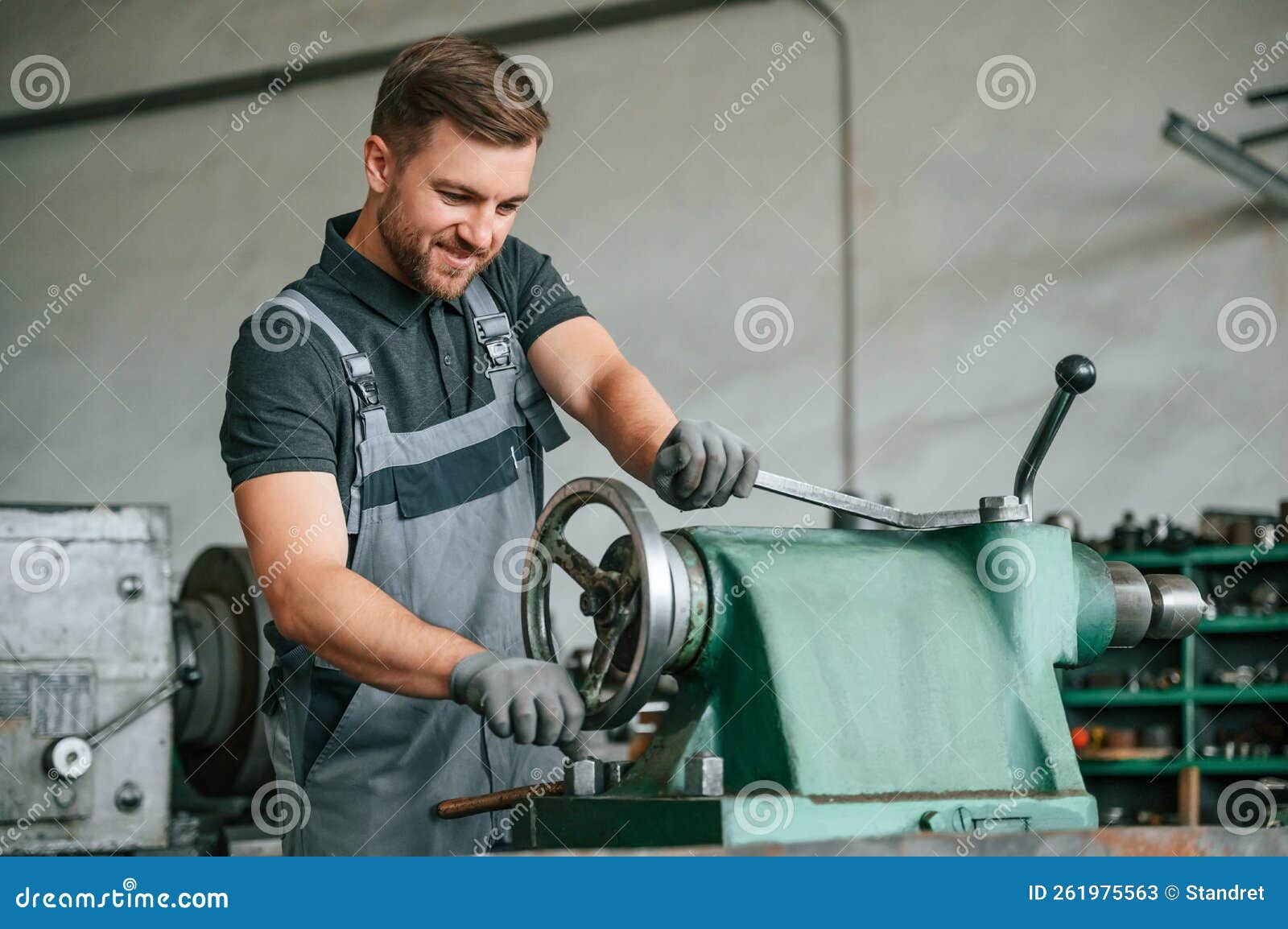 Operating Manufacturing Equipment. Man in Uniform is in Workstation ...