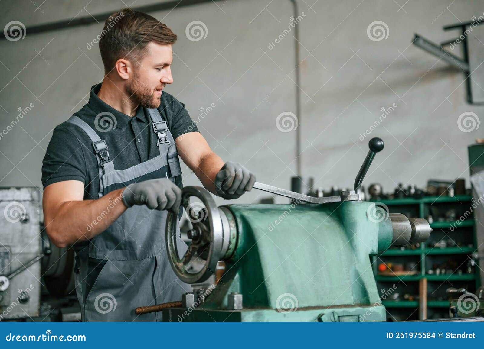 Operating Manufacturing Equipment. Man in Uniform is in Workstation ...