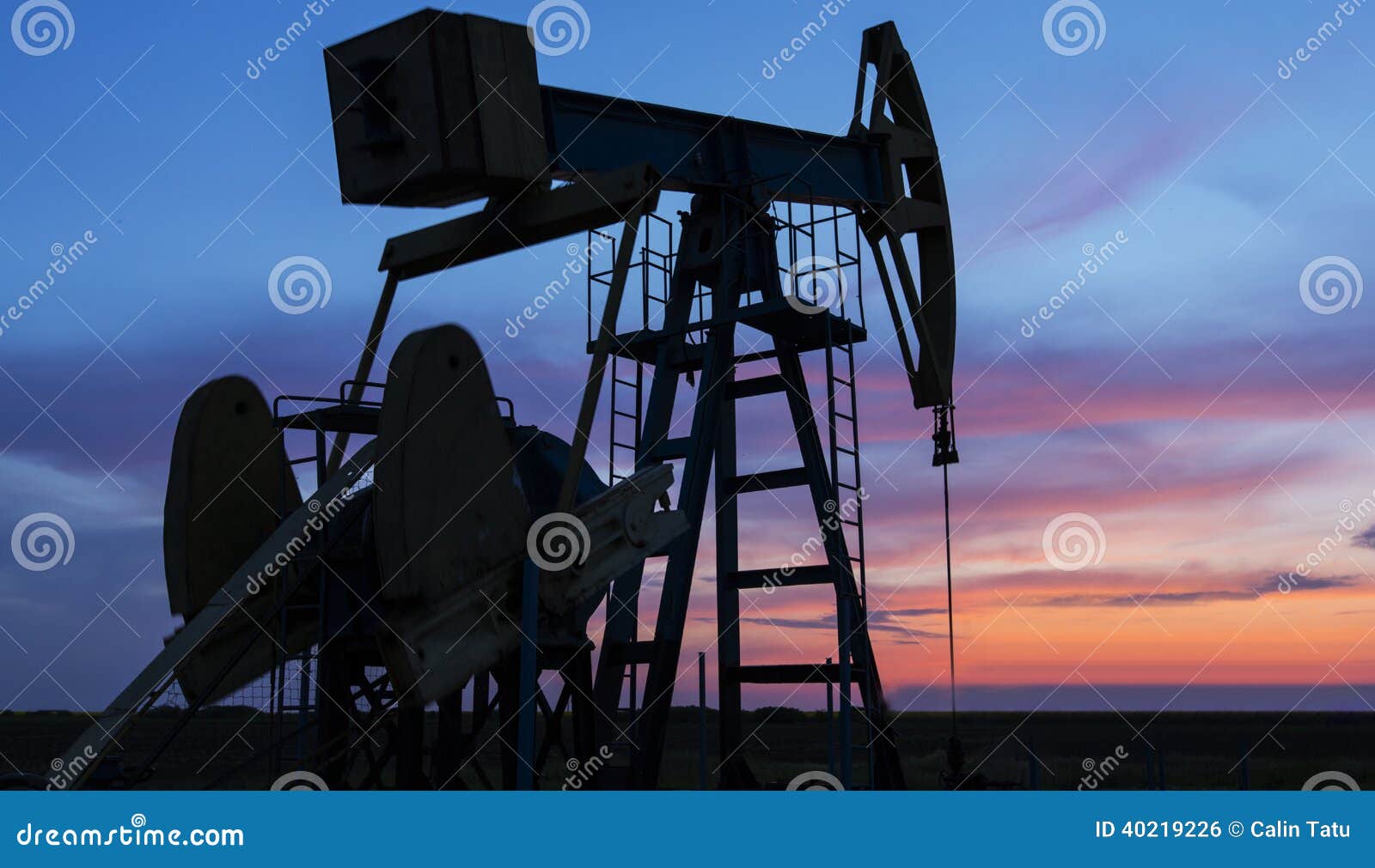 Operating Oil and Gas Well Profiled on Sunset Sky Stock Photo - Image ...