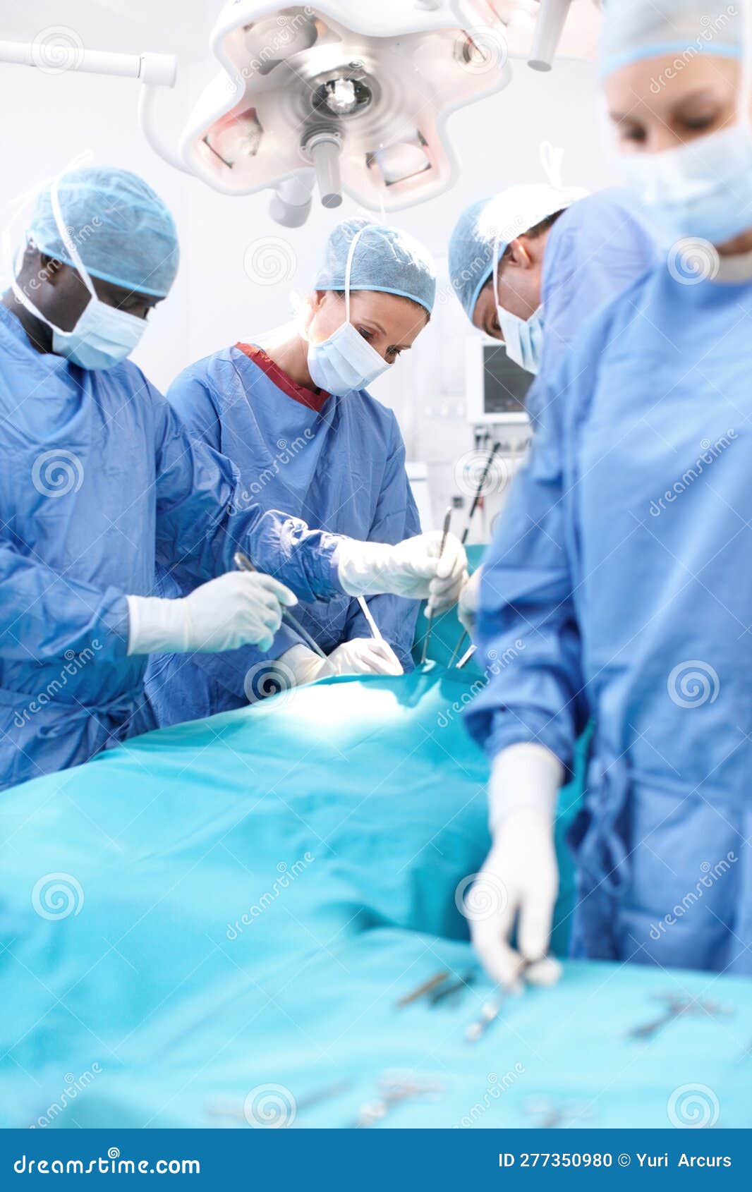 On the Operating Table. Group of Surgeons Looking at a Patient on an ...