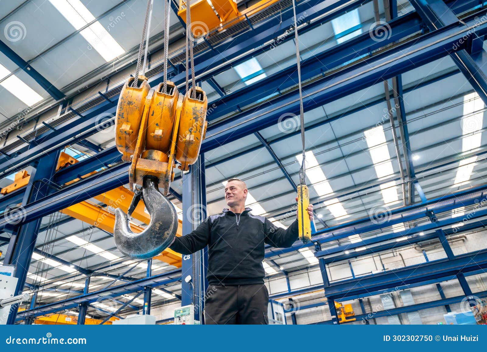 Operator Controlling a Industrial Crane in a Logistics Factory Stock ...