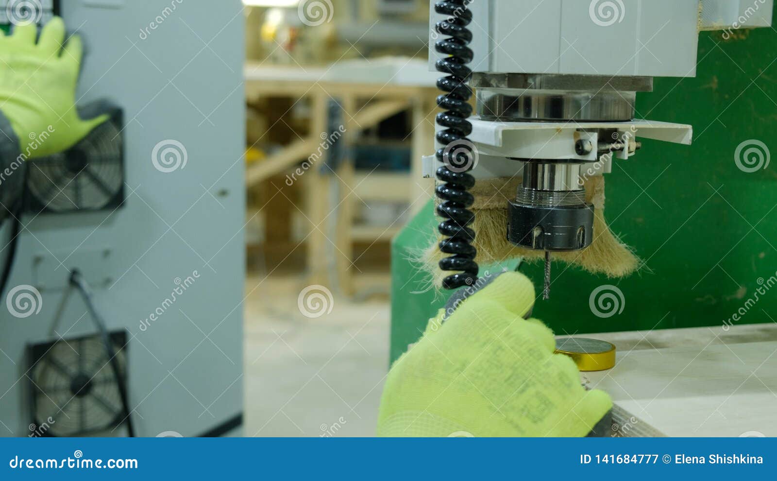 Operator of a Modern CNC Woodworking Machine Makes Adjustments before ...