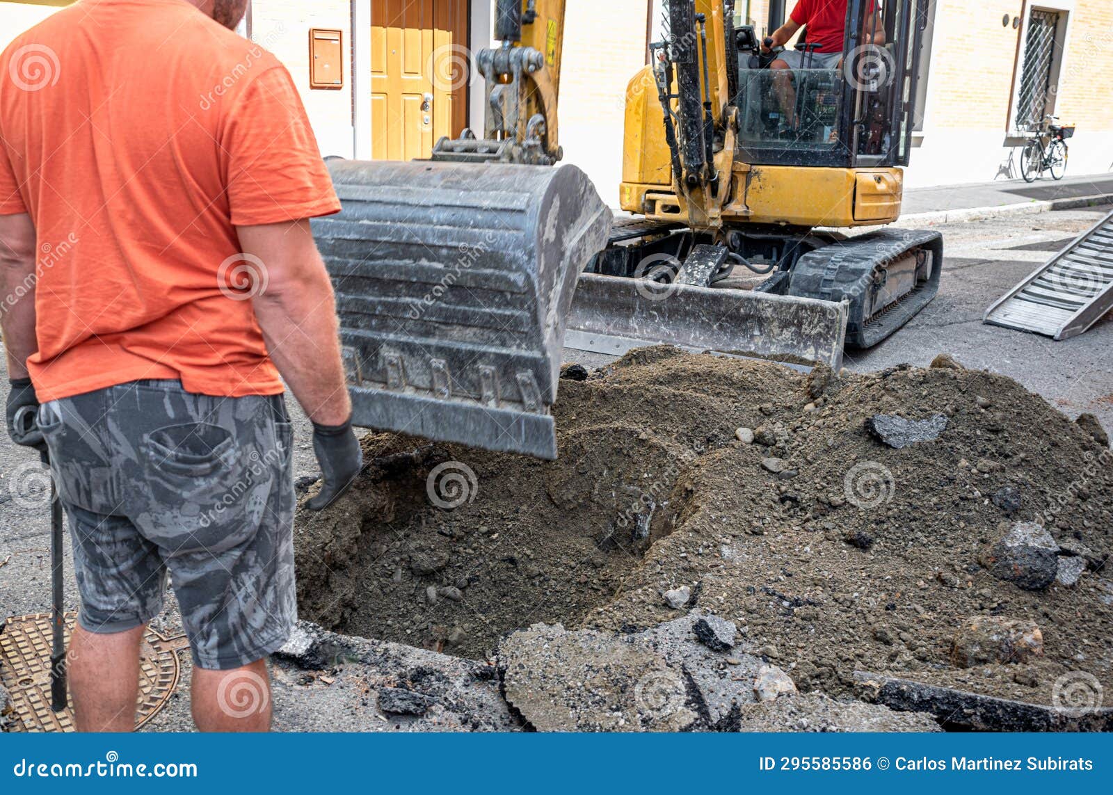 Operator Supervising Excavator while Digging in Construction Area Stock ...