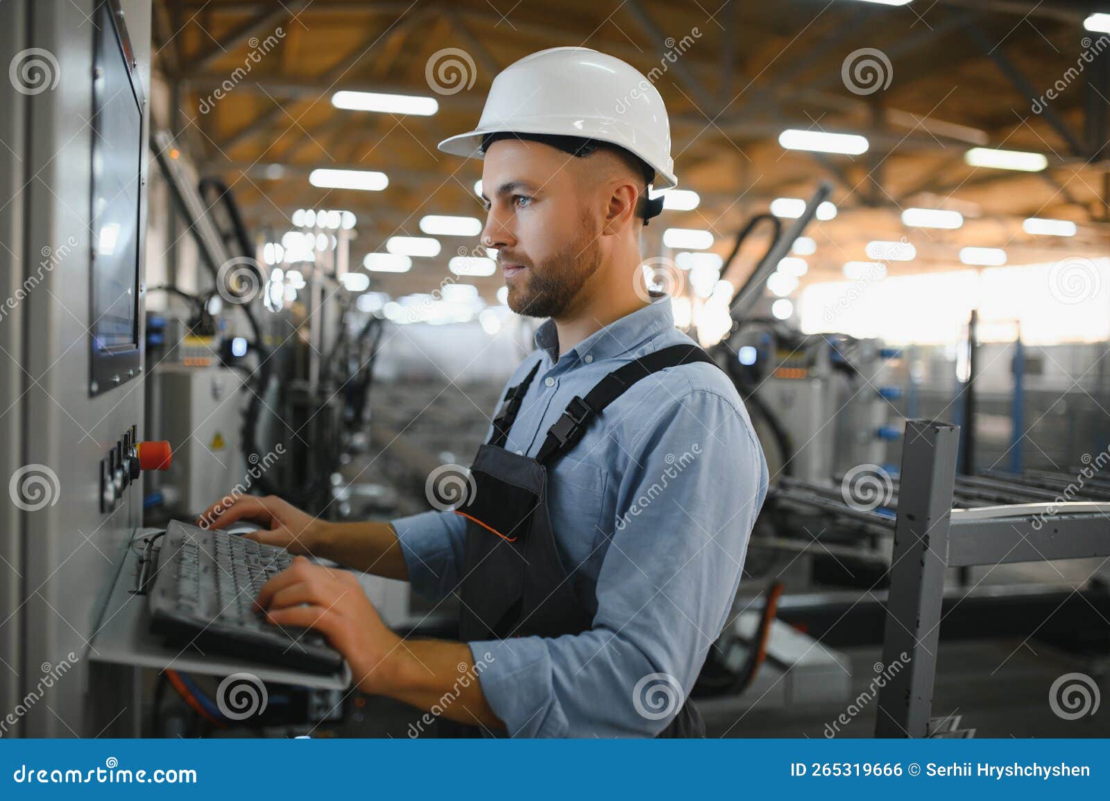 Operator Wearing Safety Hat Behind Control Panel on a Factory Stock ...
