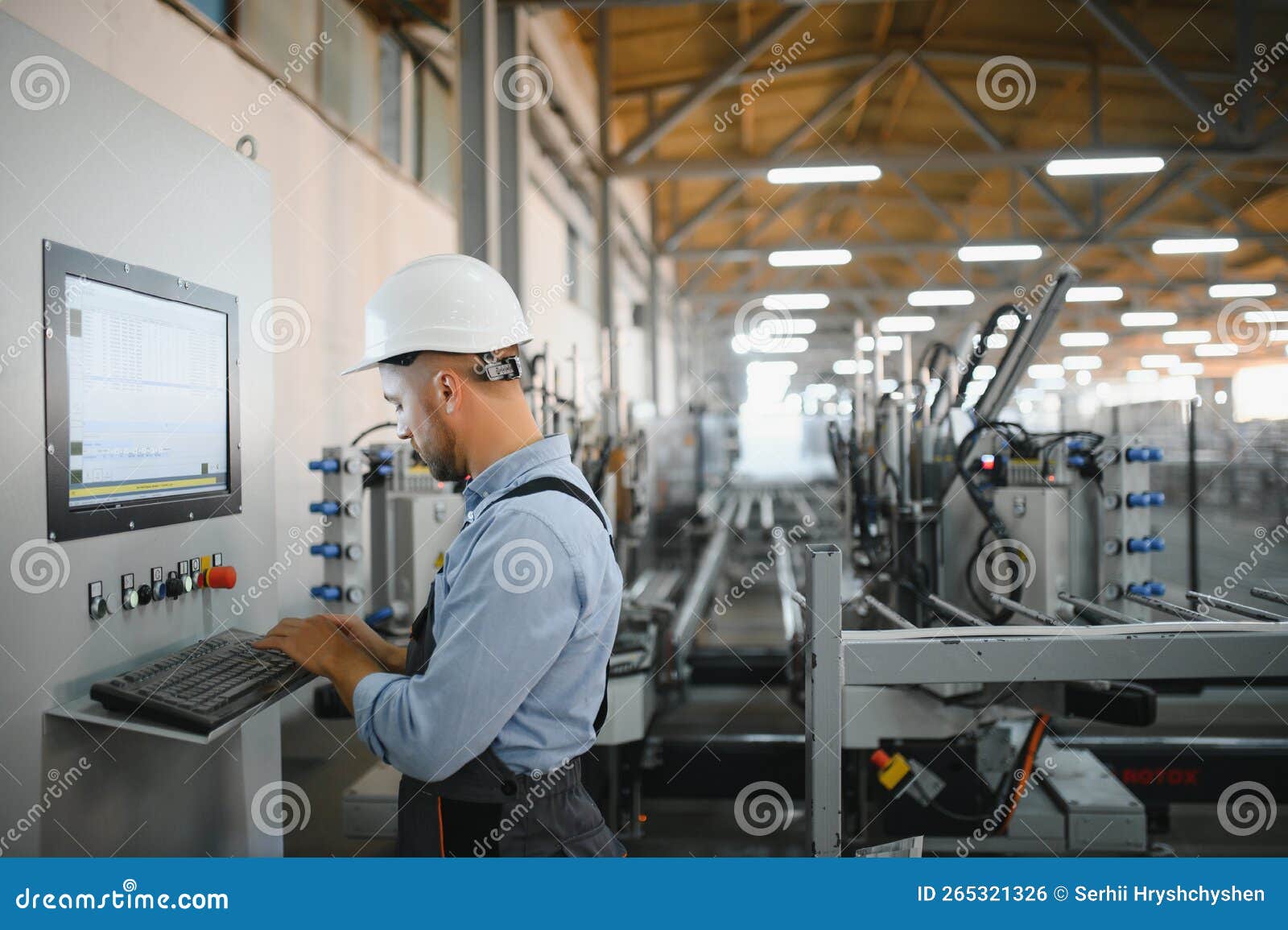 Operator Wearing Safety Hat Behind Control Panel on a Factory Stock ...
