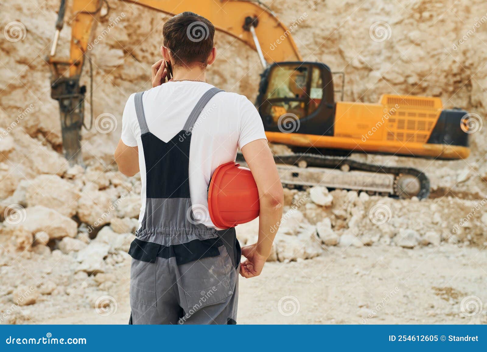 Operator is Working on the Borrow Pit. Man in Professional Uniform ...