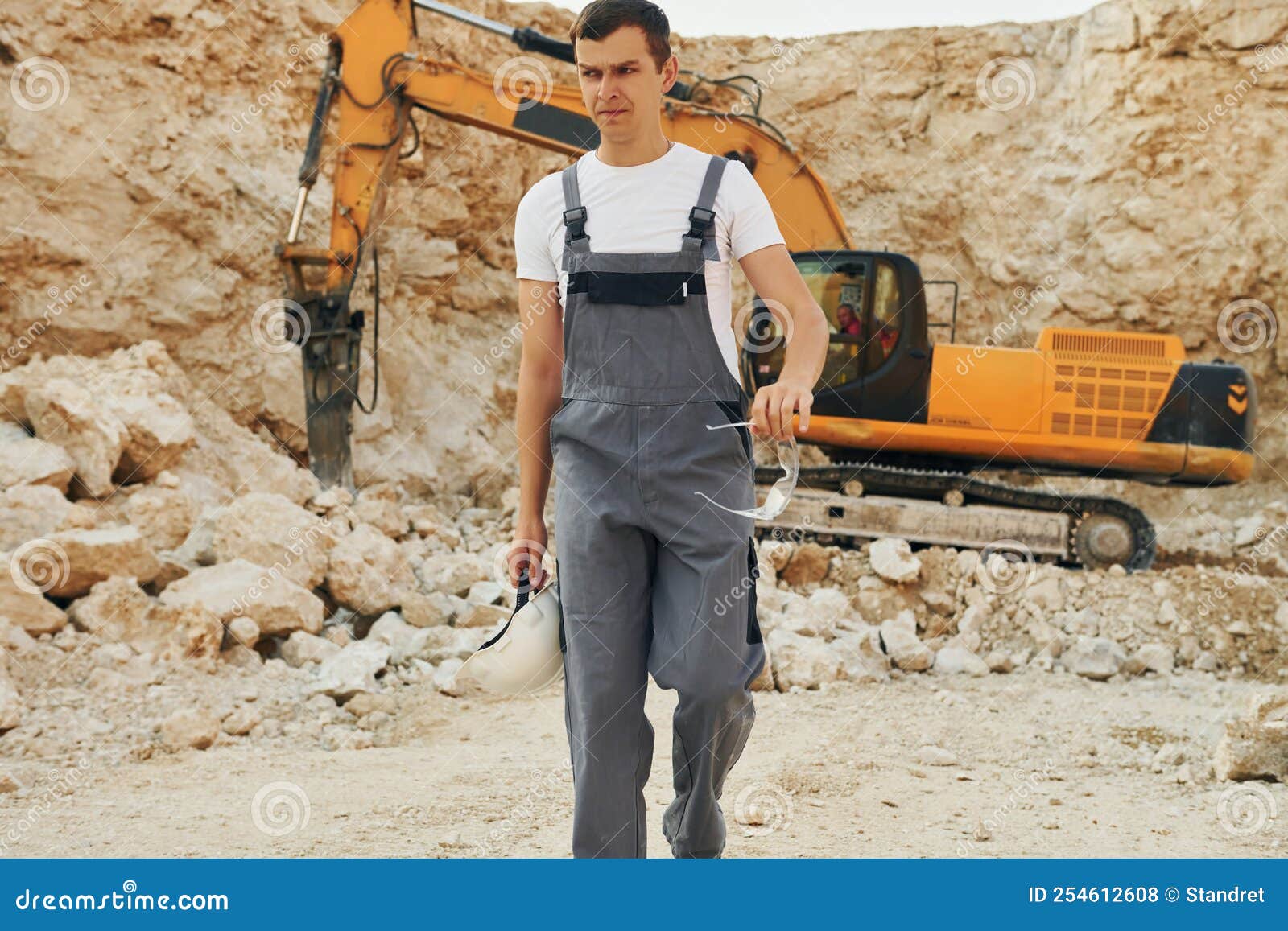 Operator is Working on the Borrow Pit. Man in Professional Uniform ...