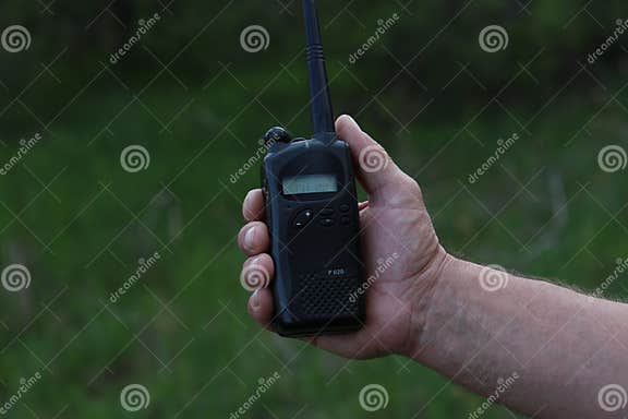 The Operator at the Workplace Allocates Workers with a Walkie-talkie ...