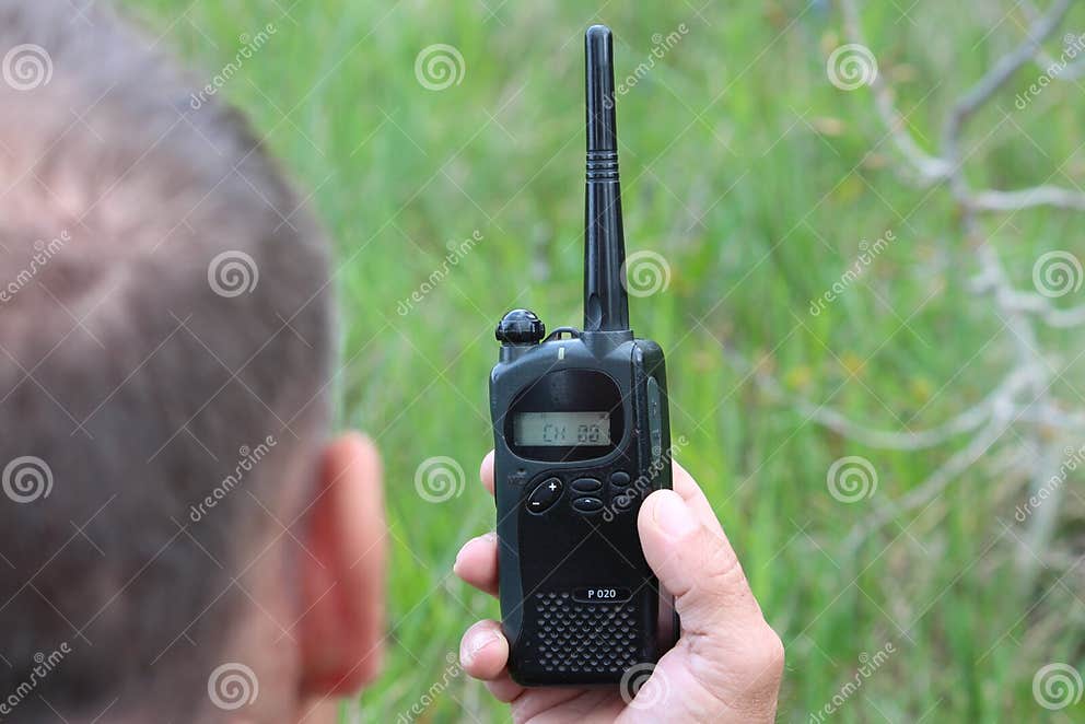 The Operator at the Workplace Allocates Workers with a Walkie-talkie ...