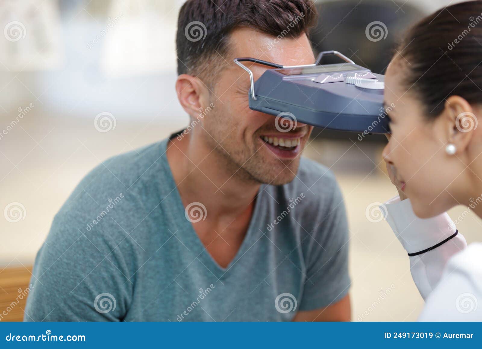 Ophthalmologist Using Handheld Device To Inspect Patients Eyes Stock ...