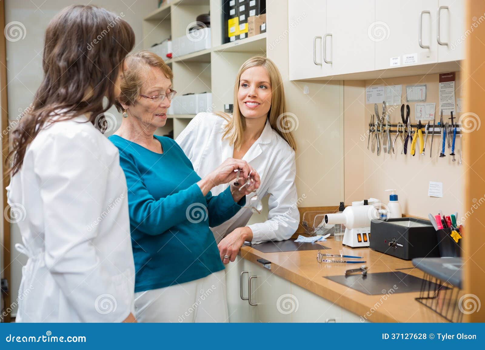 Optician with Apprentices Repairing Glasses Stock Photo - Image of ...