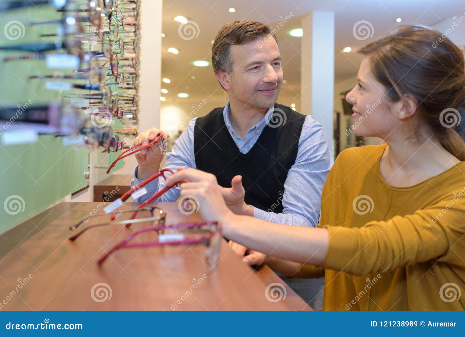 Optician with Customer Choosing Frames Stock Image - Image of eyewear ...
