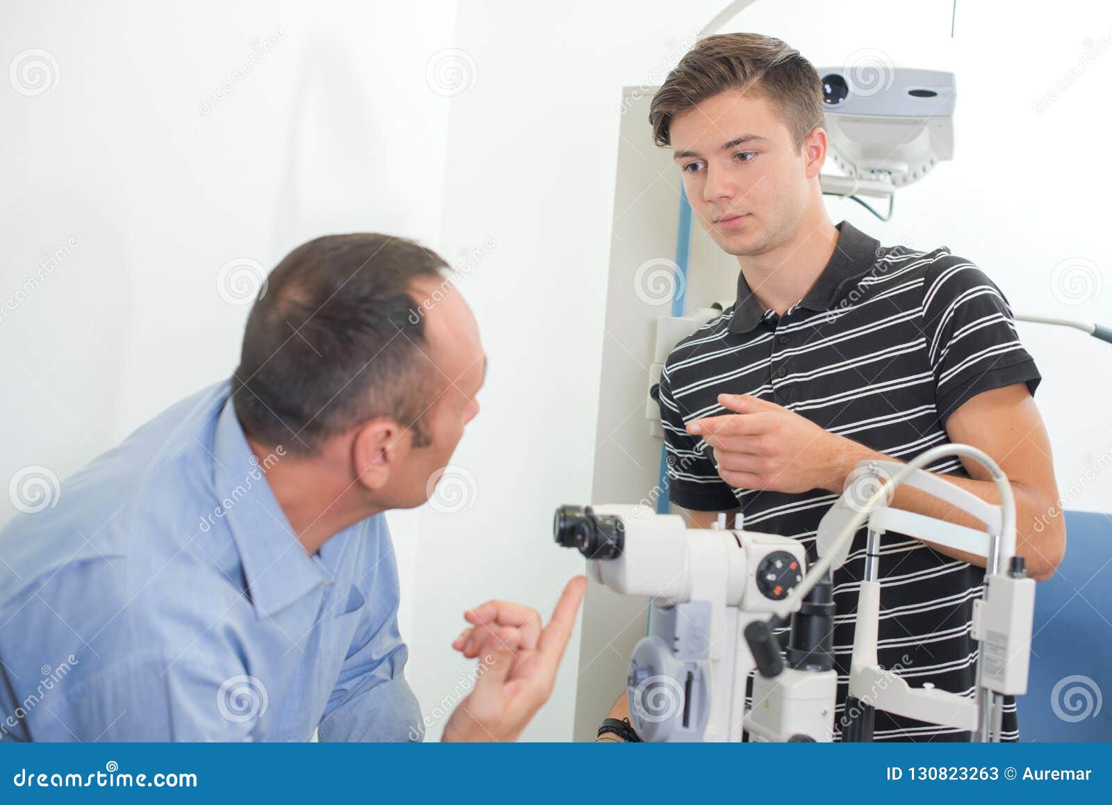 Optician in Discussion with Apprentice Stock Image - Image of ...