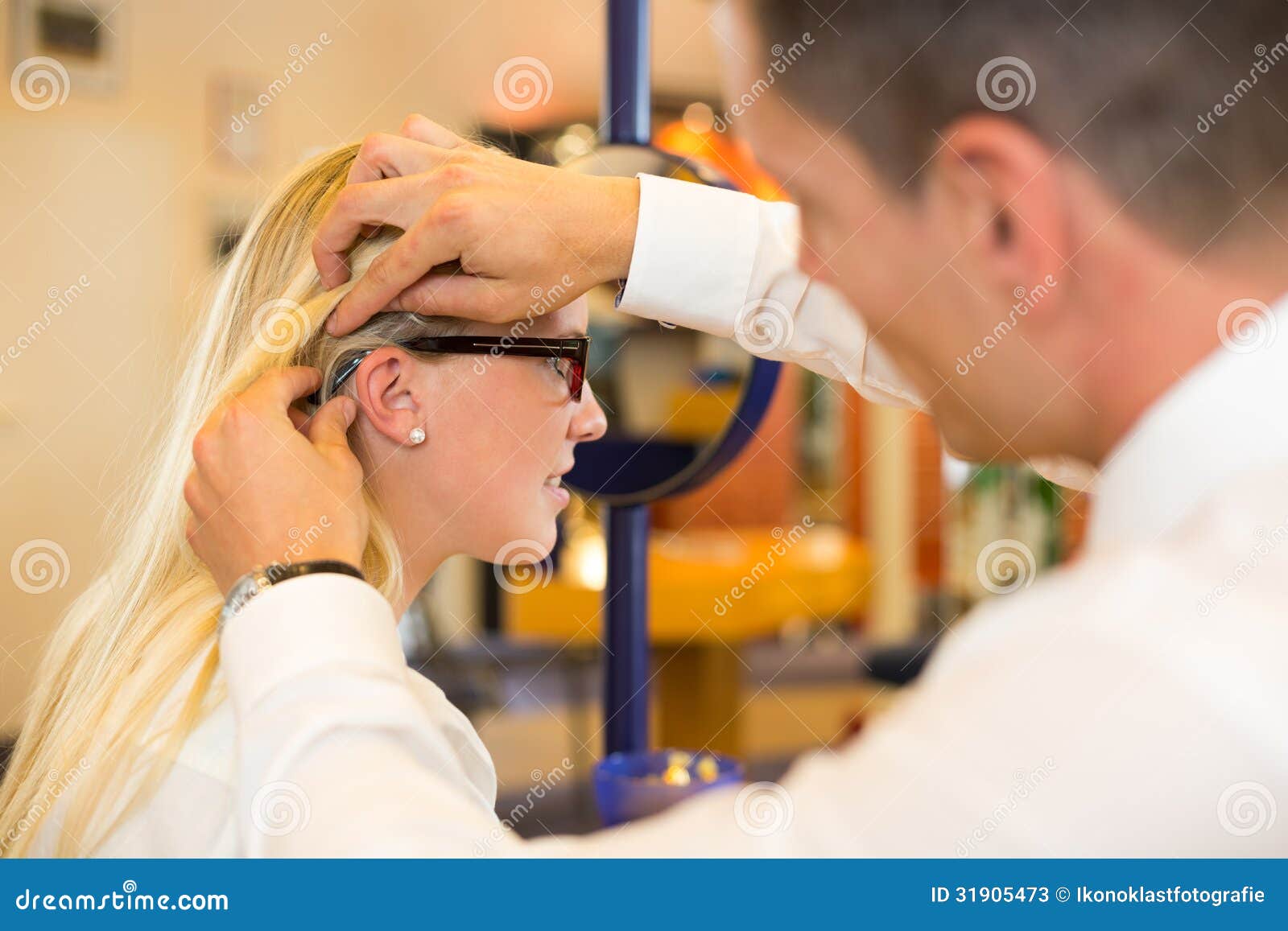 Optician Examining Correct Fit of Eyeglass Frame for Customer Stock ...