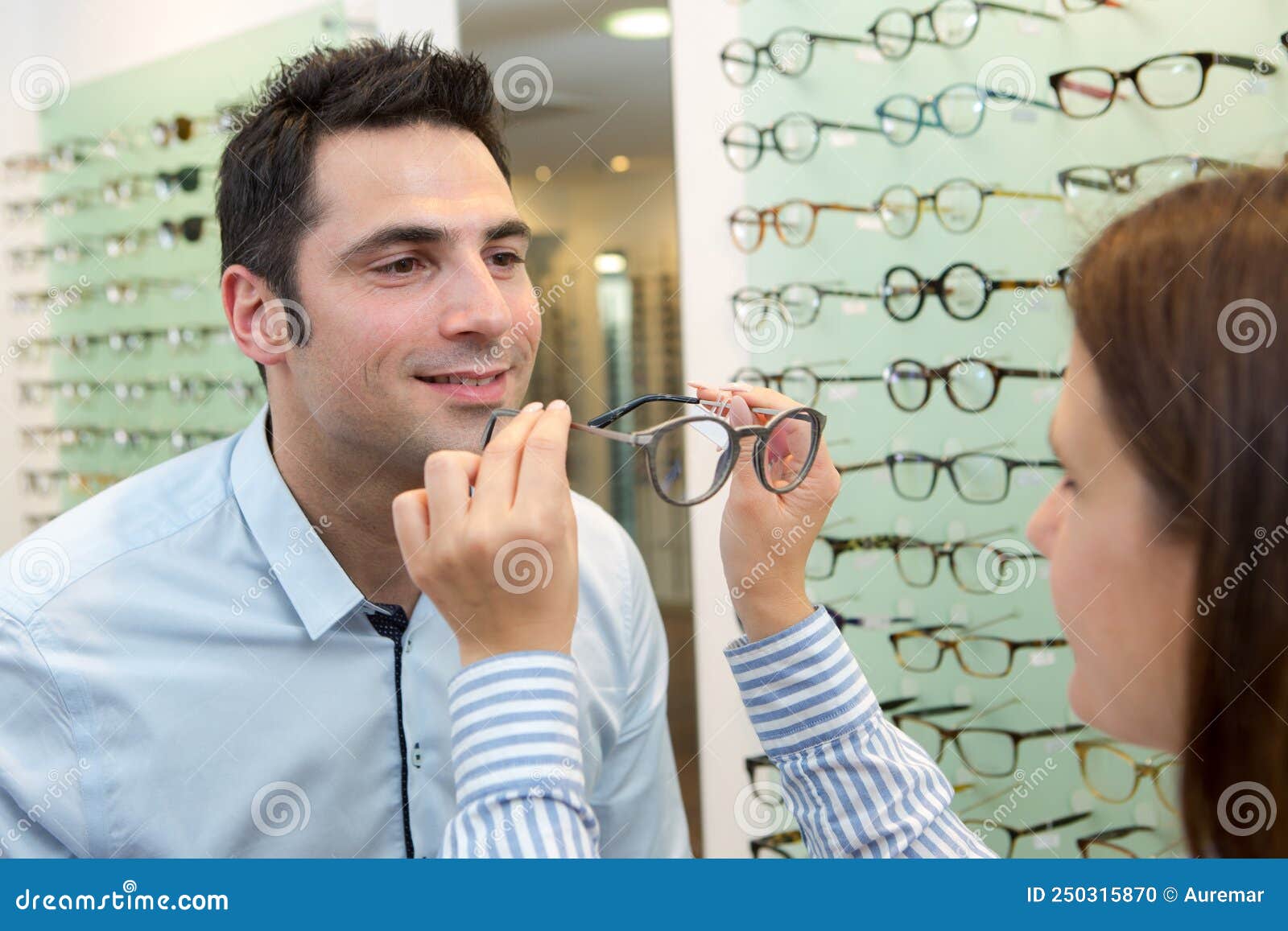 Optician Fitting Eyeglasses To Client Stock Photo - Image of eyeglasses ...
