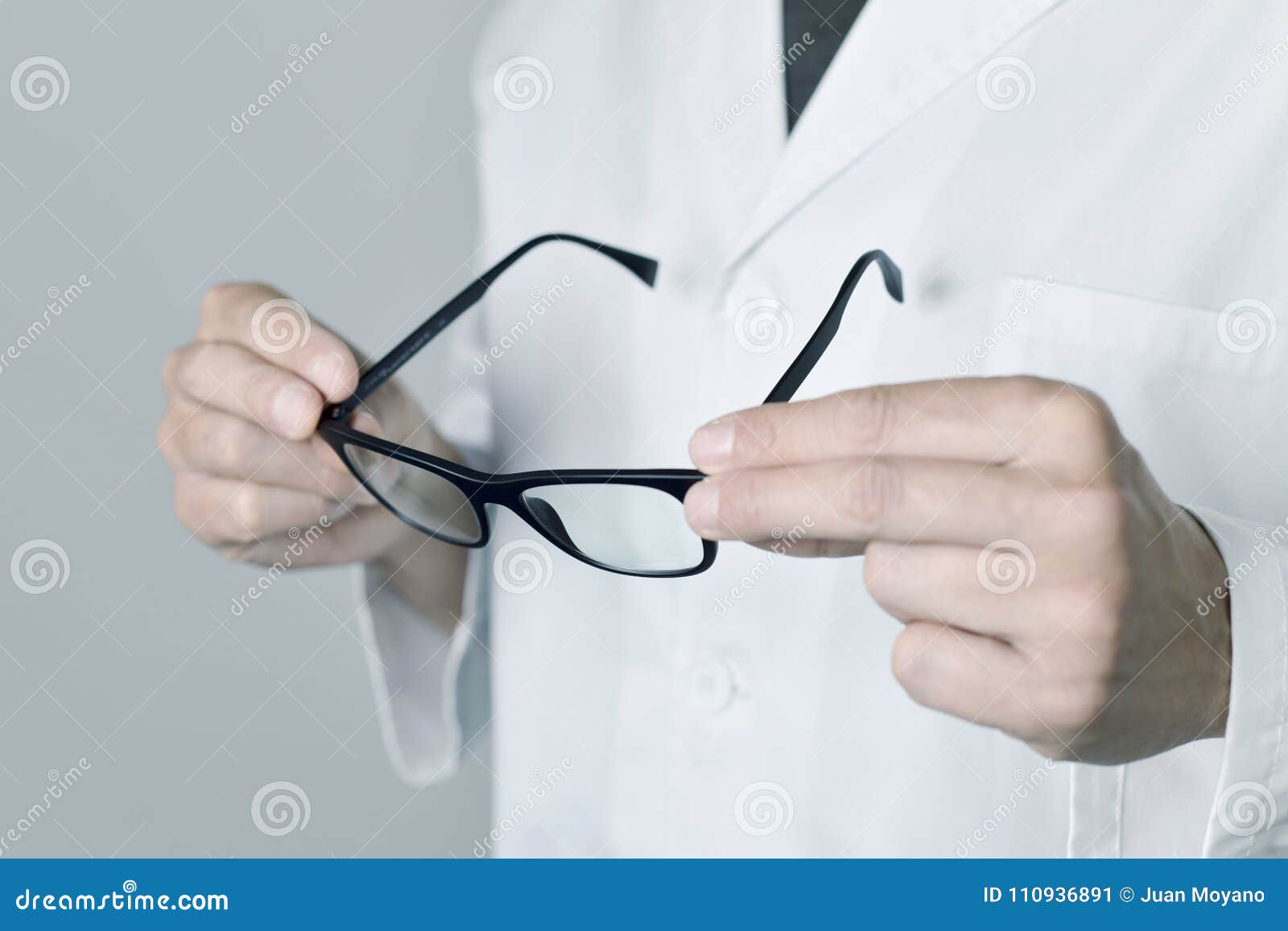 Optician Man Checking a Pair of Eyeglasses Stock Image - Image of ...