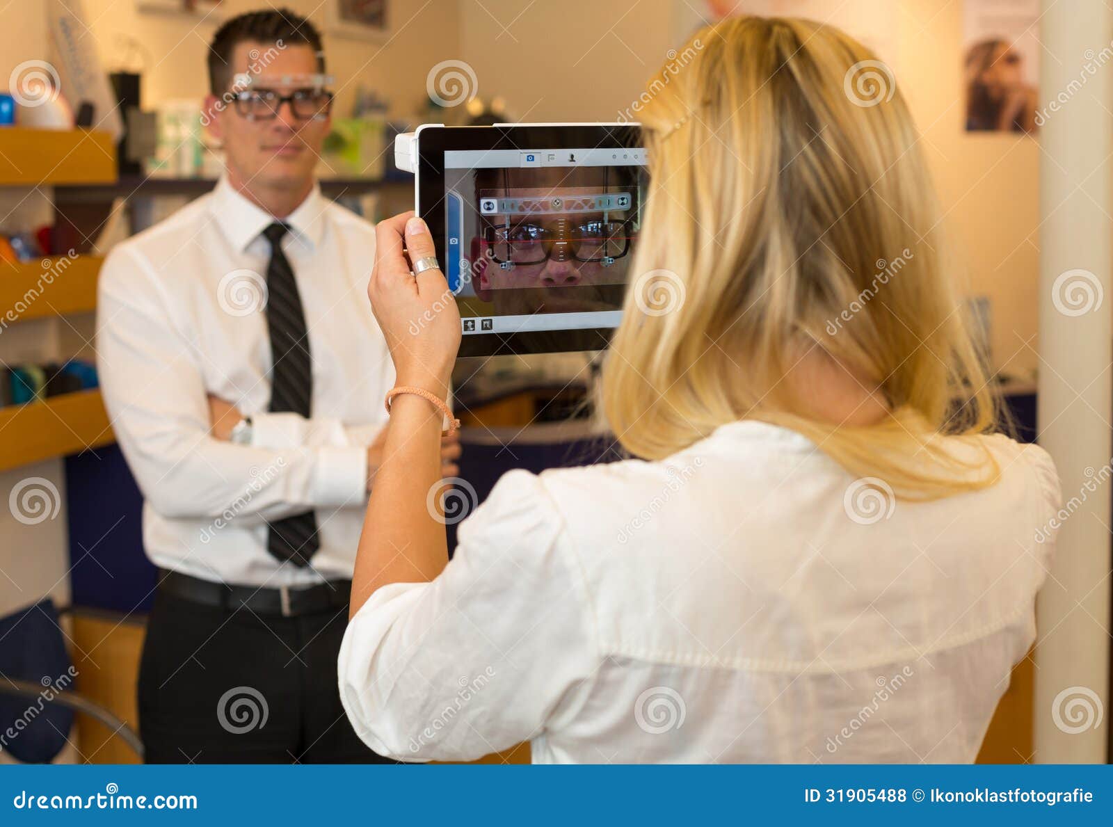 Optician or Optometrist Measuring the Eye Distance of a Customer Stock ...