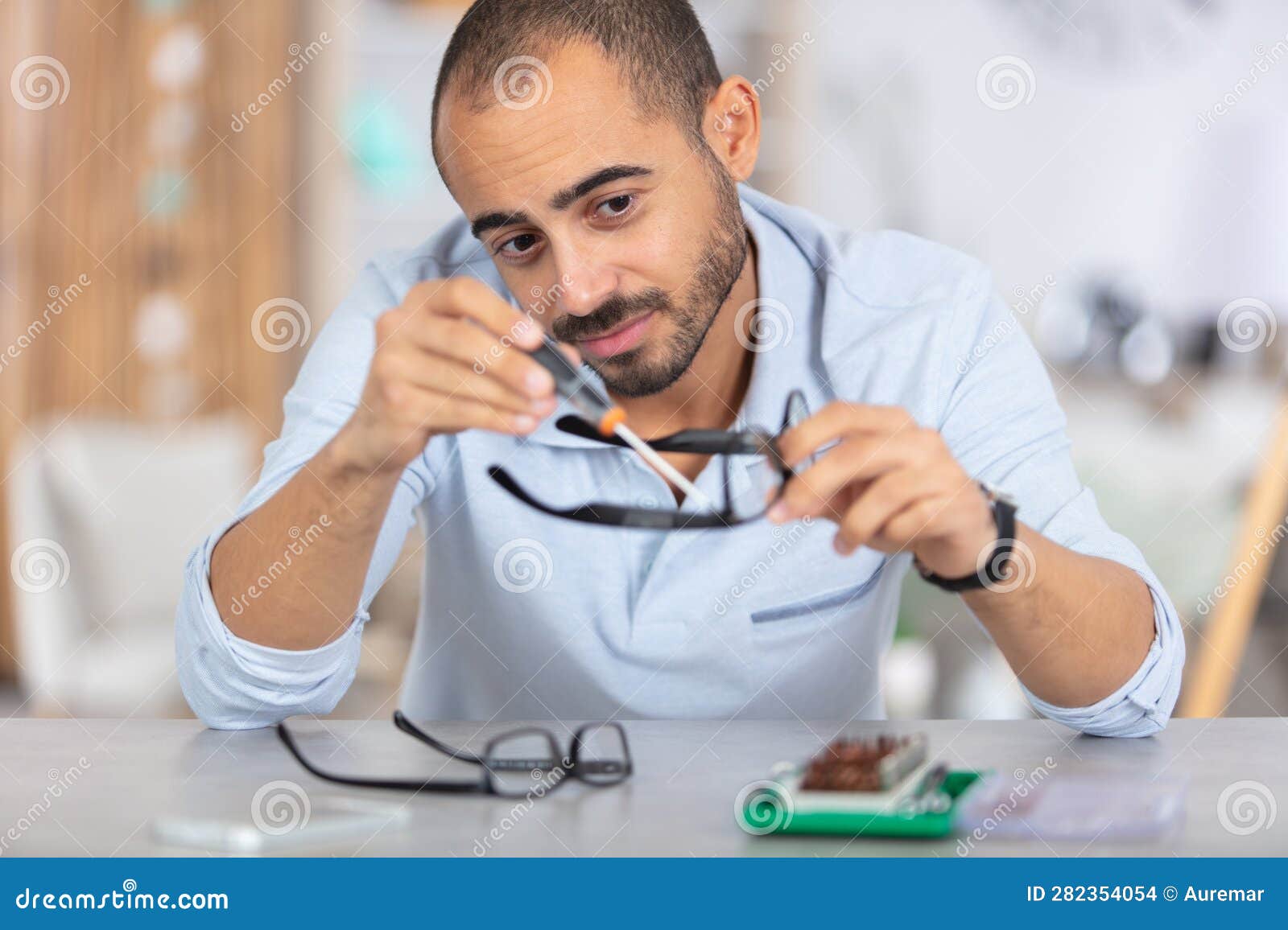 Optician Repairing Broken Glasses in Workshop Stock Photo - Image of ...