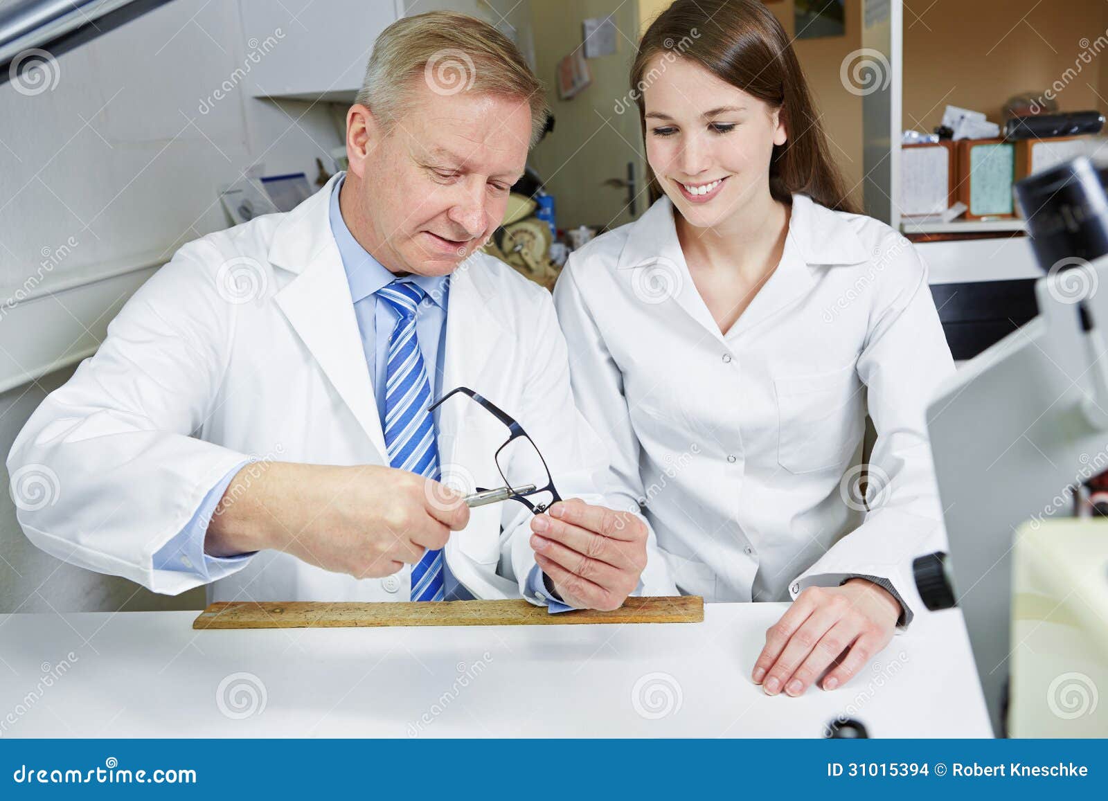Optician Teaching Apprentice Stock Photo - Image of hand, trainee: 31015394