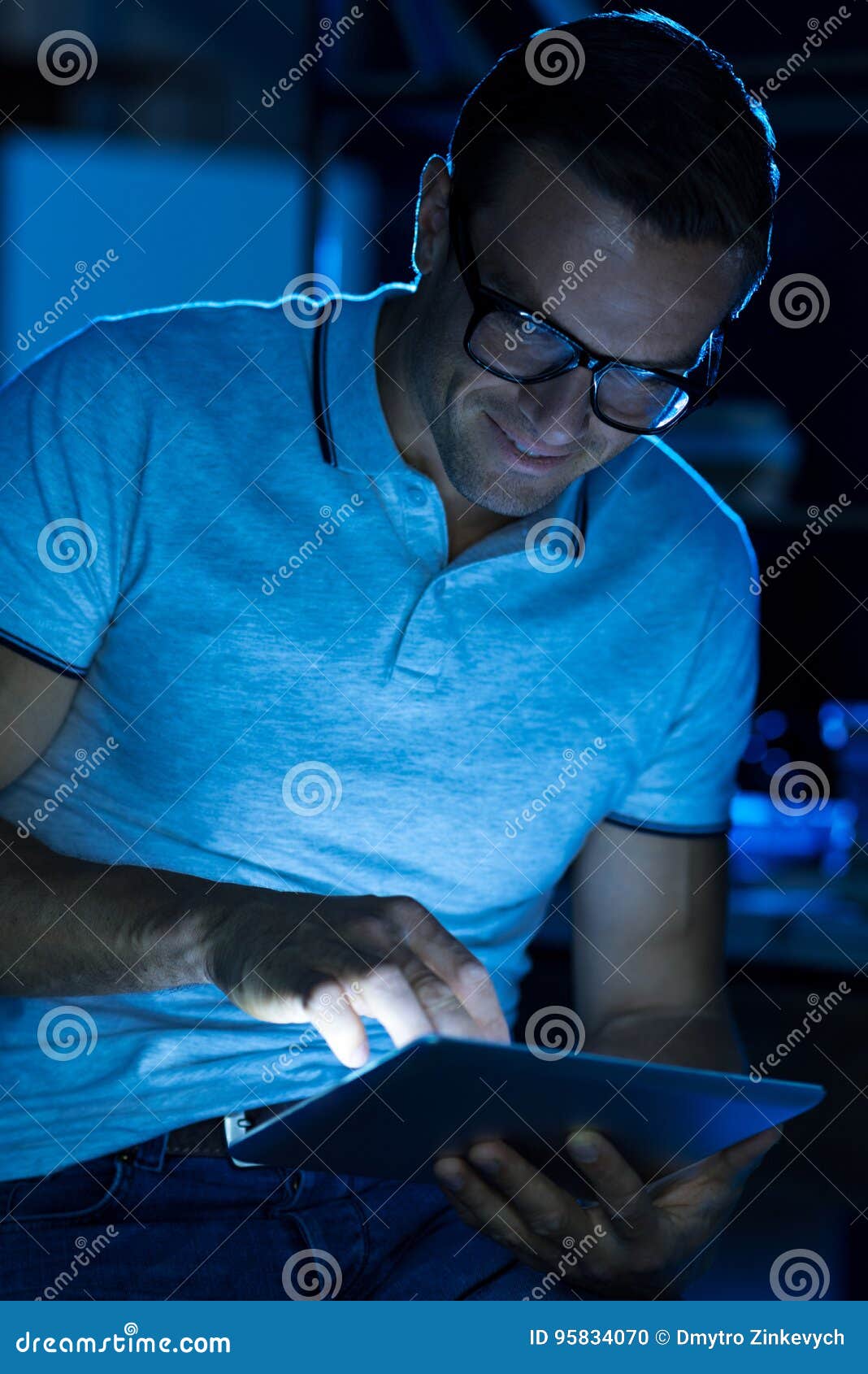 Optimistic Clever Man Reading Something on His Tablet Stock Photo ...