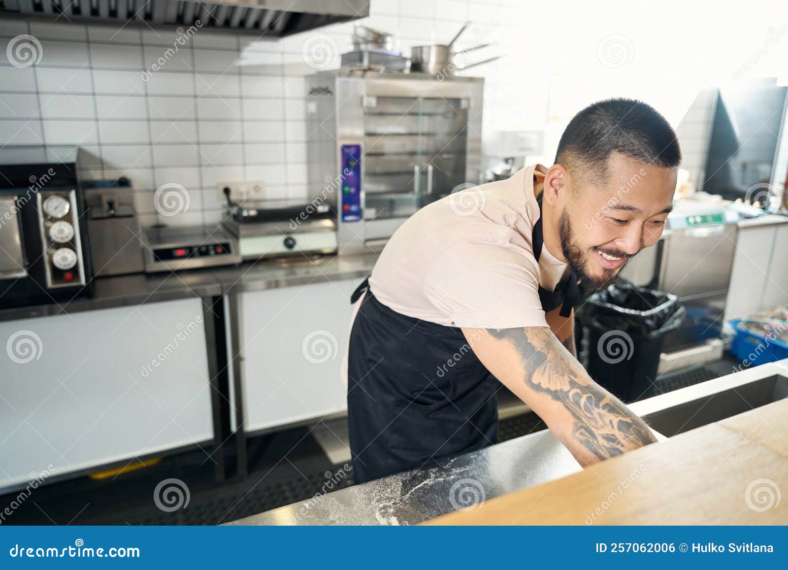 Optimistic Culinary Worker Checking the Oven in His Kitchen Stock Photo ...