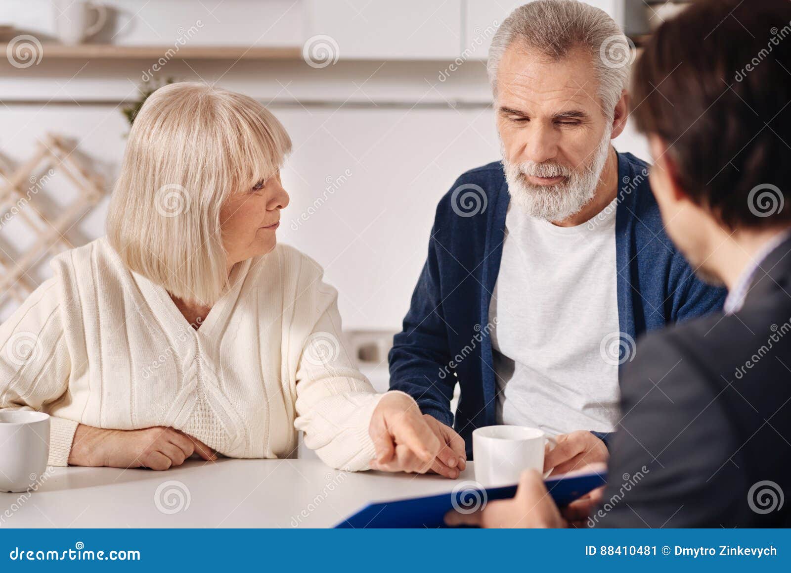 Optimistic Senior Couple Having Conversation with Advisor at Home Stock ...