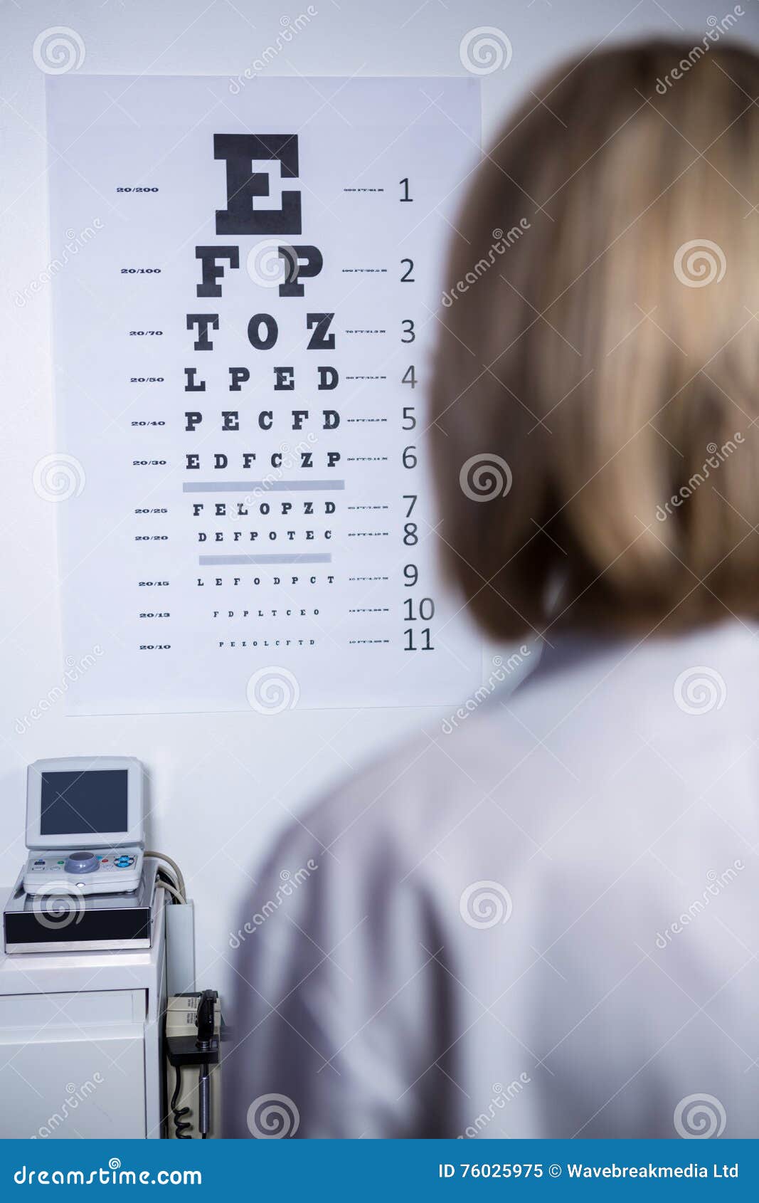Optometrist Looking at Eye Chart Stock Image - Image of coat ...
