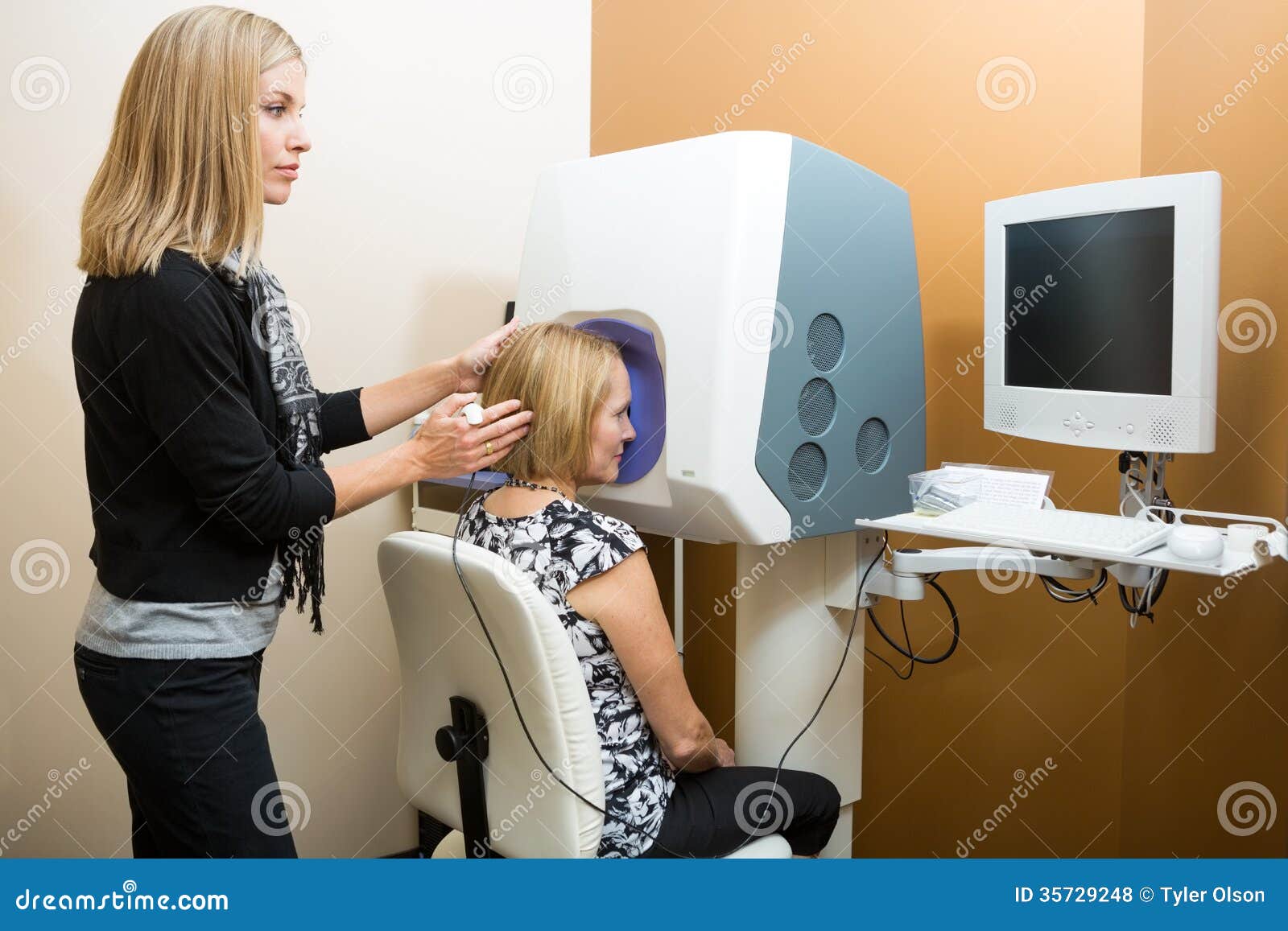 Optometrist with Patient Looking at Computer for Stock Photo - Image of ...