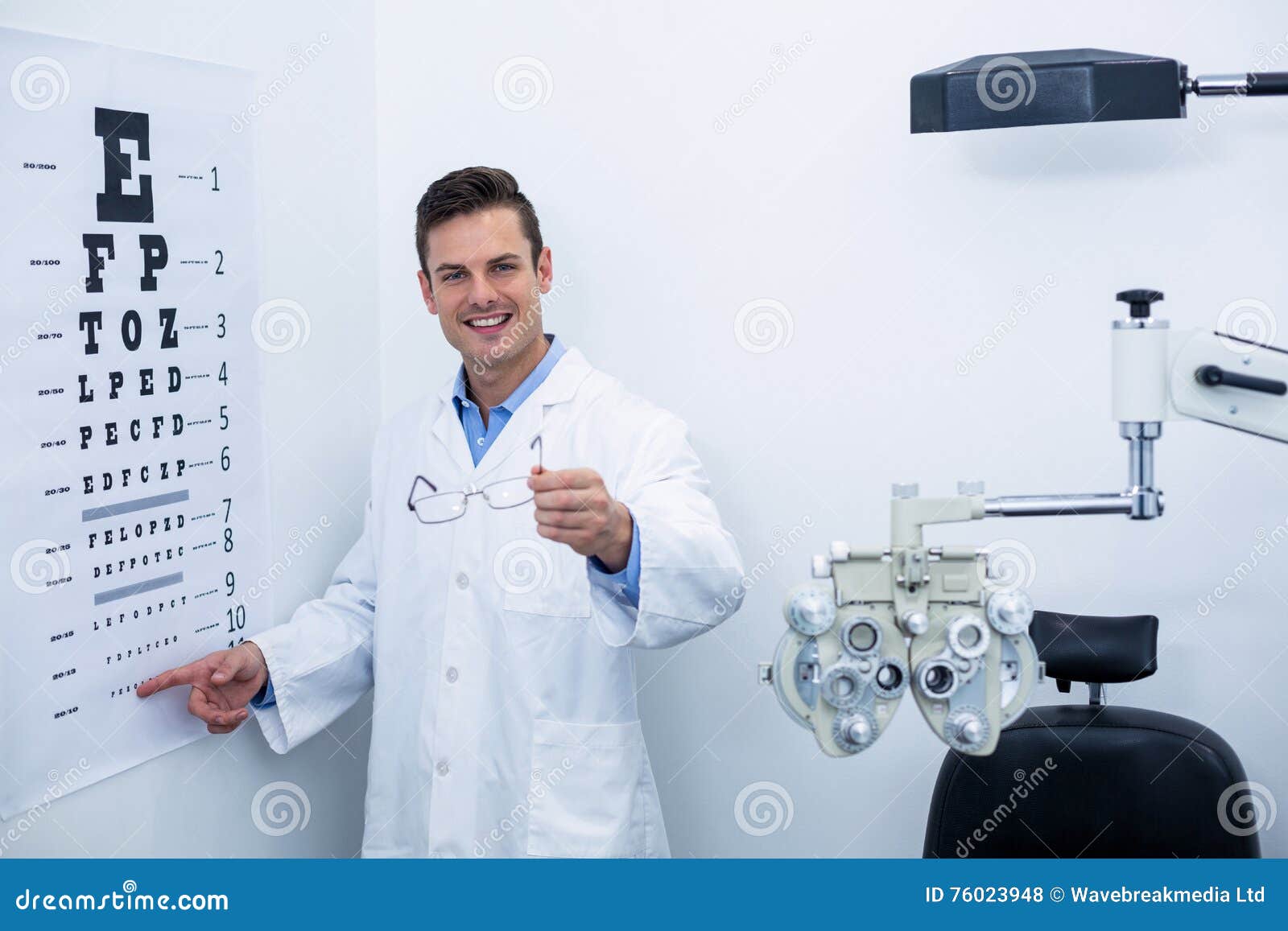 Optometrist Pointing at Eye Chart Stock Photo - Image of medical ...