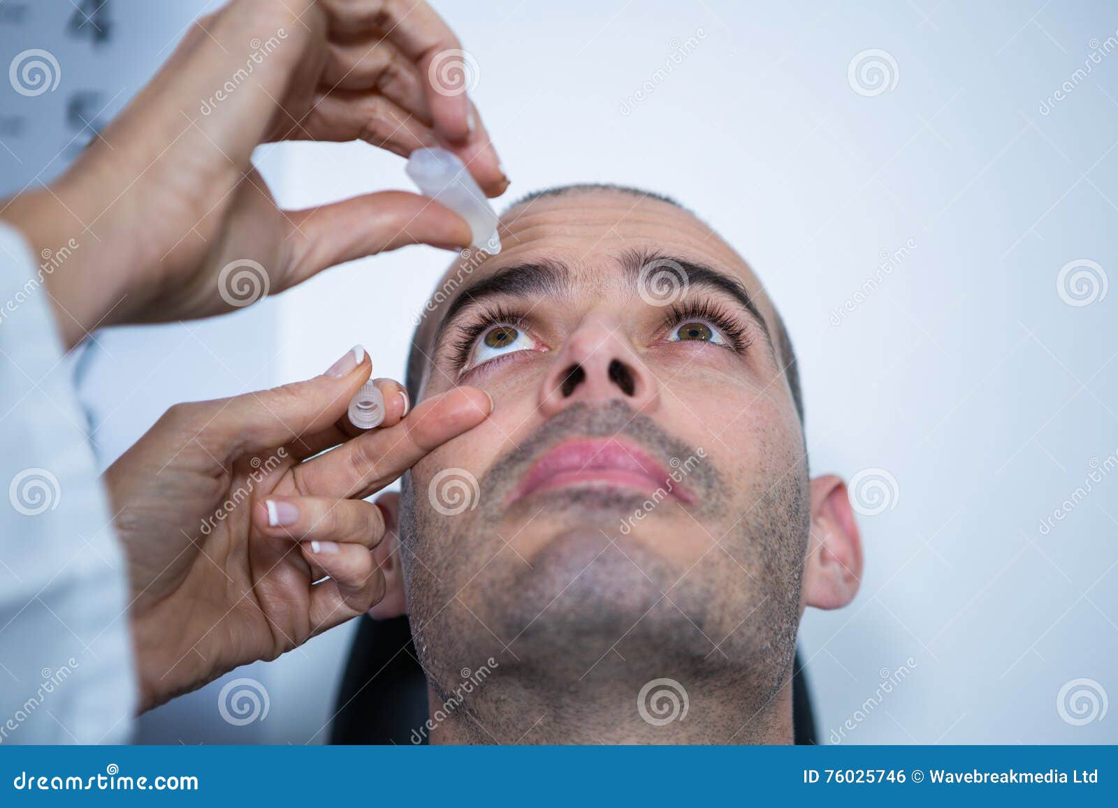Optometrist Putting Drops into Patients Eyes Stock Photo - Image of ...