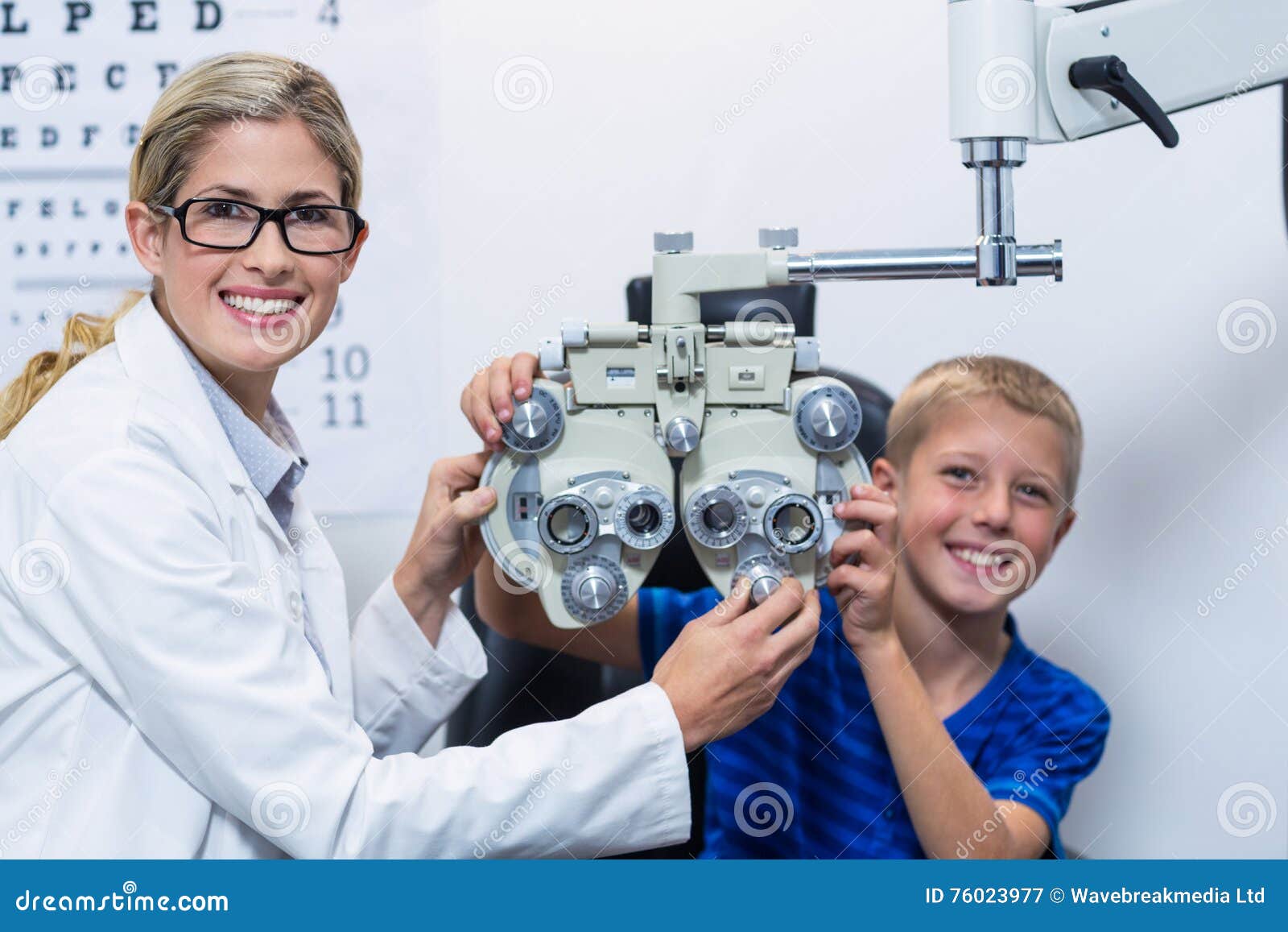 Optometrist and Young Patient Smiling while Under Going Eye Test Stock ...
