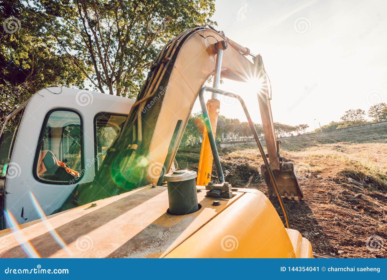 Orange Backhoe is on the Ground with Sunset Stock Image - Image of ...