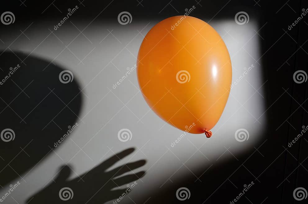 Orange Balloon with Shadow and Hand Shadow Stock Photo - Image of ...