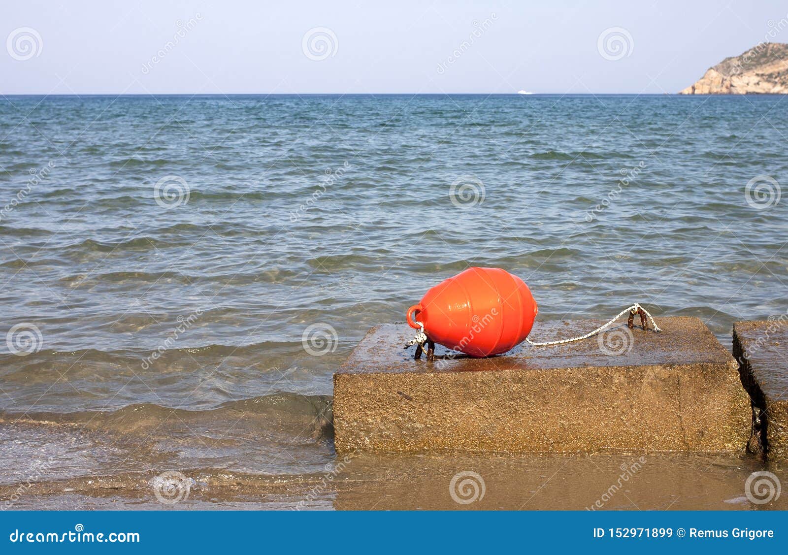 Orange beacon on a rock stock image. Image of rope, water - 152971899