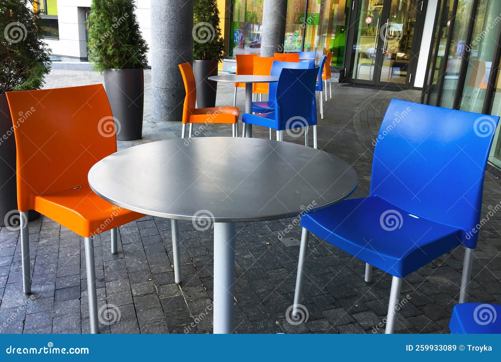 Orange and Blue Chairs and Round Tables in Outdoor Cafe Stock Image ...