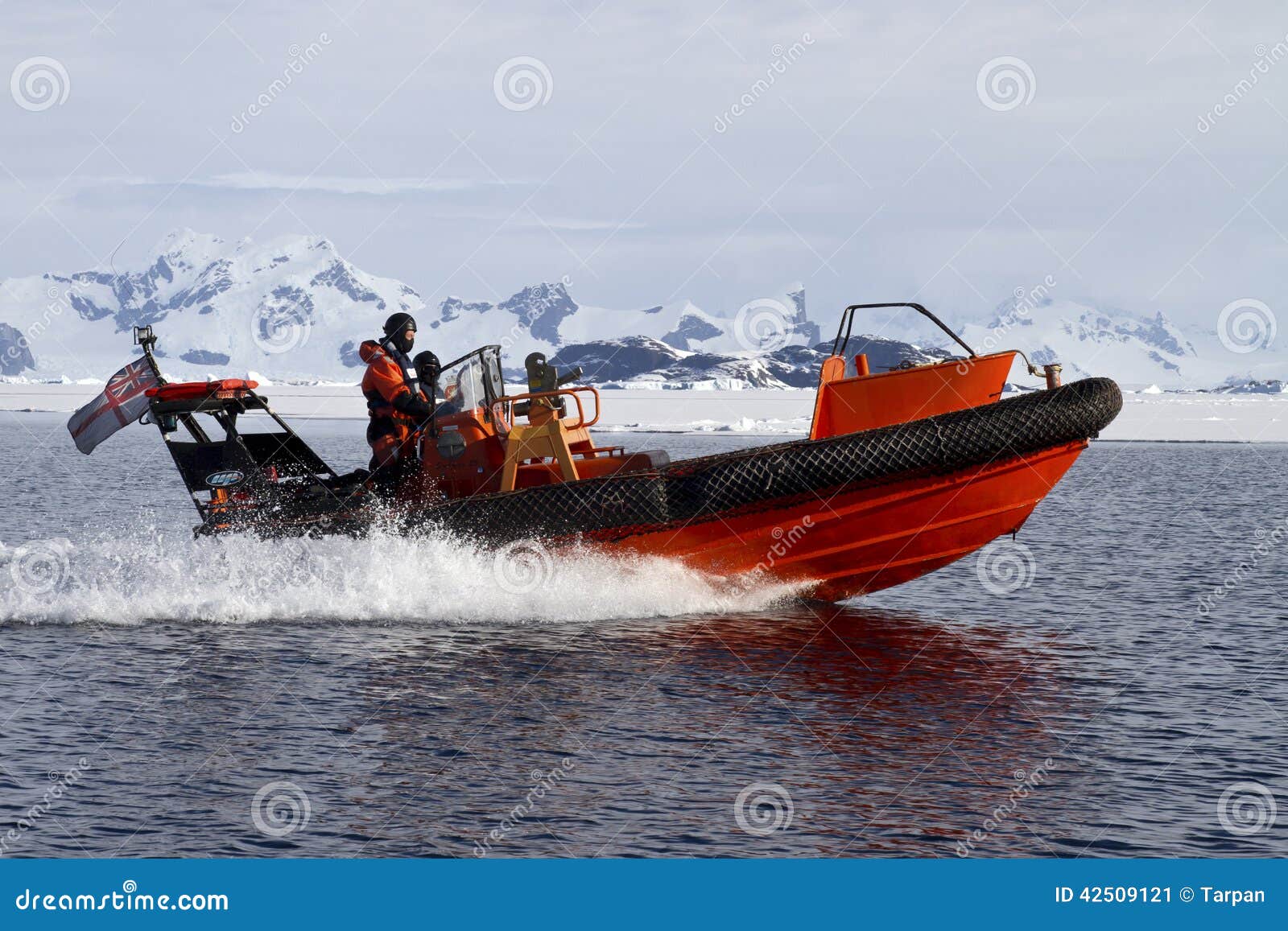 Orange Boat Sailing at High Speed in Antarctic Waters Against Mo ...