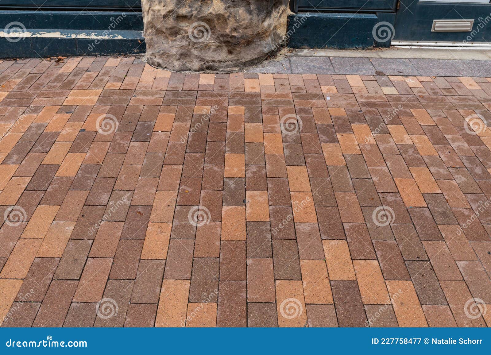 Orange Brick Sidewalk beside a Building with Rusticated Stone Pillar ...