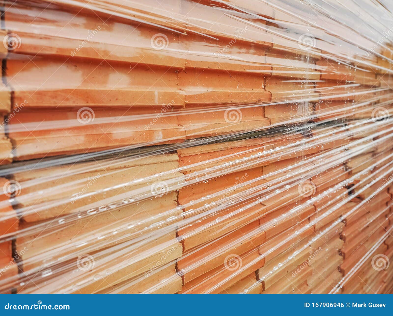 Orange Bricks Wrapped in Plastic Wrap. Construction Material Stock ...