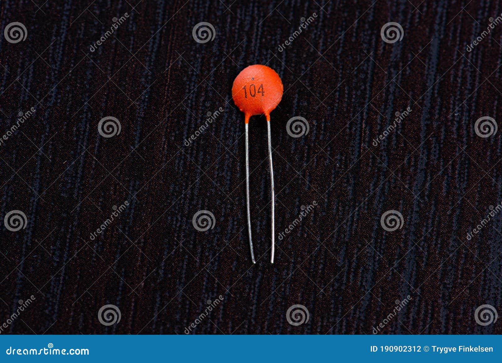 An Orange Ceramic Capacitor on Black Background Stock Photo - Image of ...