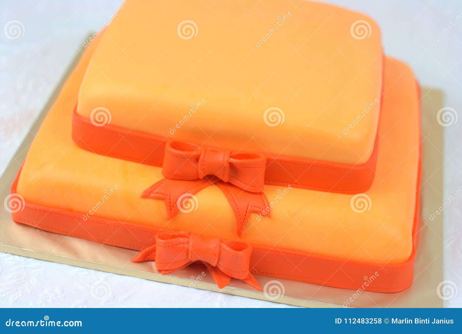 Orange square 2 tier cake stock photo. Image of color - 112483258