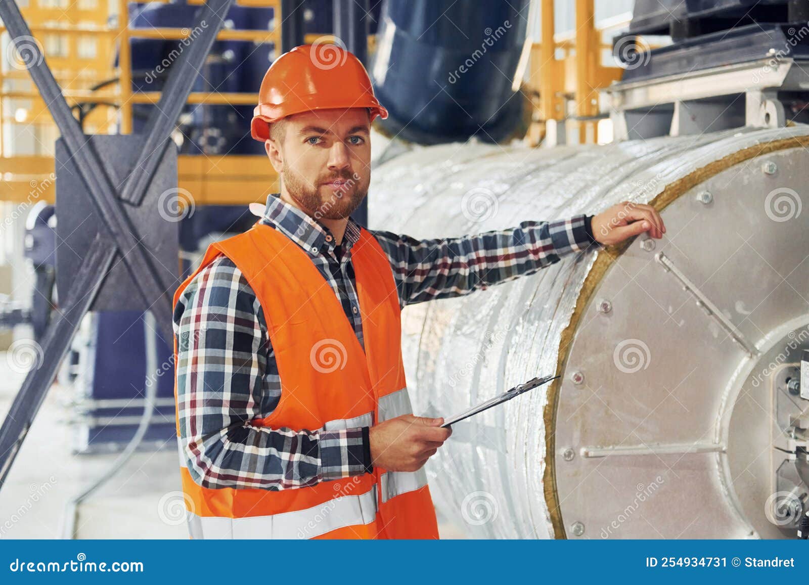 In Orange Colored Hard Hat. Construction Worker in Uniform is in the ...