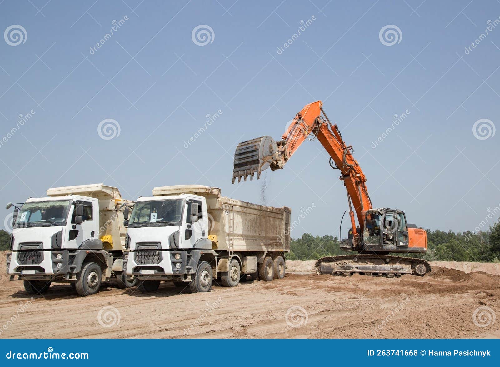 Orange Crawler Excavator and Two Gray Construction Dump Trucks in the Process of Loading and ...