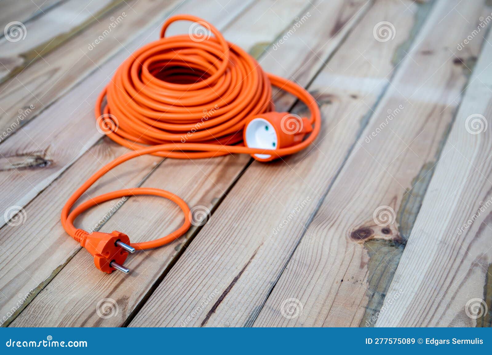 Orange Electrical Extension Cord Coiled on Wood Texture Background ...
