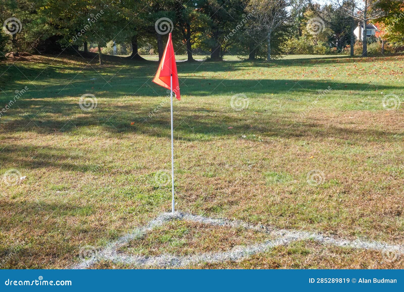 An Orange Flag on a Painted White Boundary Line on a Large Grassy ...