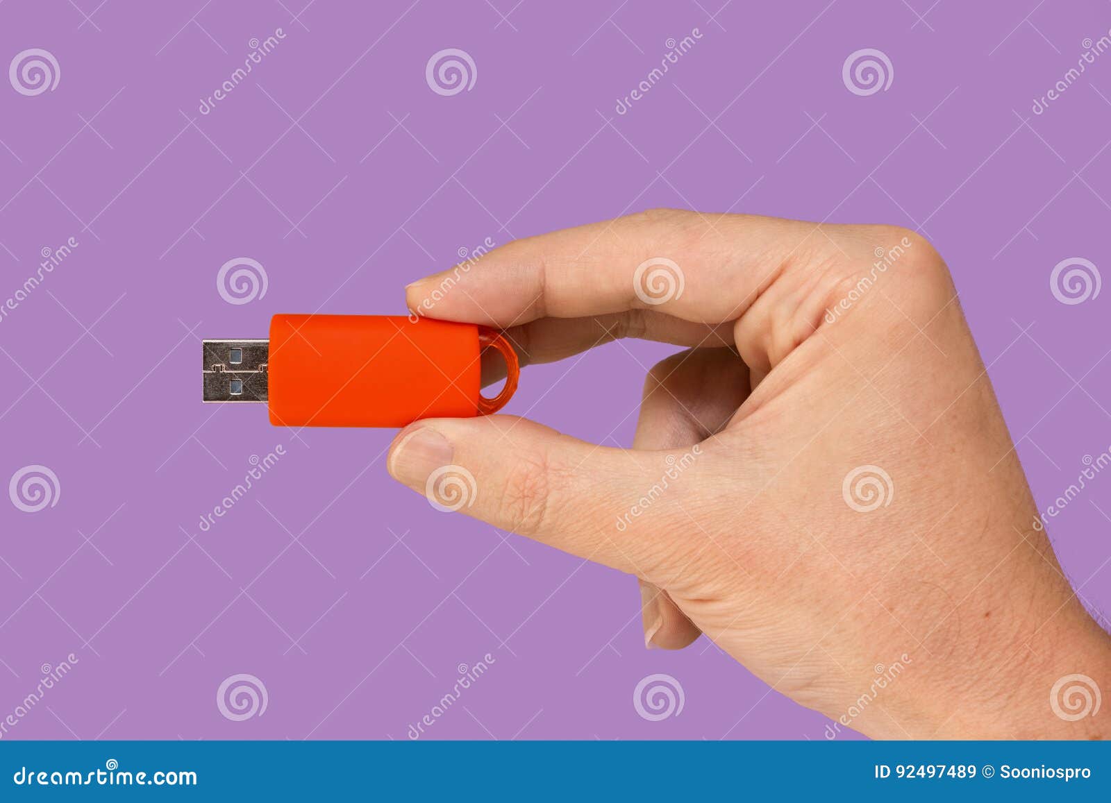 Orange Flash Memory on Hand with Violet Background Stock Image - Image ...