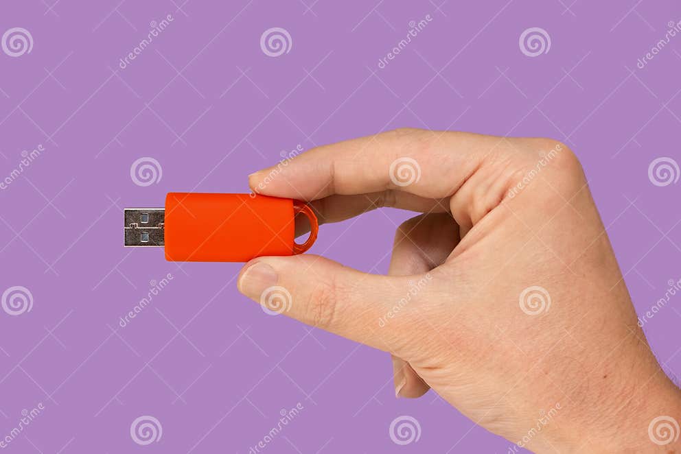 Orange Flash Memory on Hand with Violet Background Stock Image - Image ...