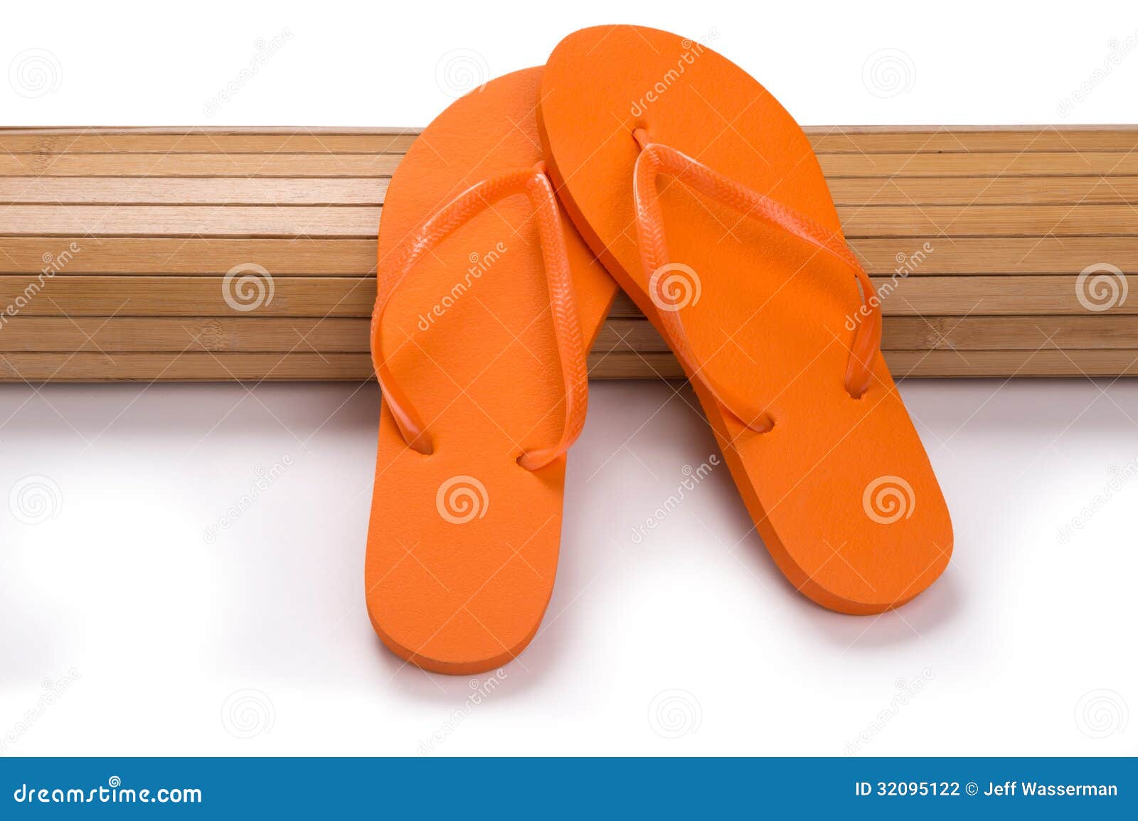 Orange Flip Flops on Rolled Bamboo Mat Stock Photo - Image of sandal ...