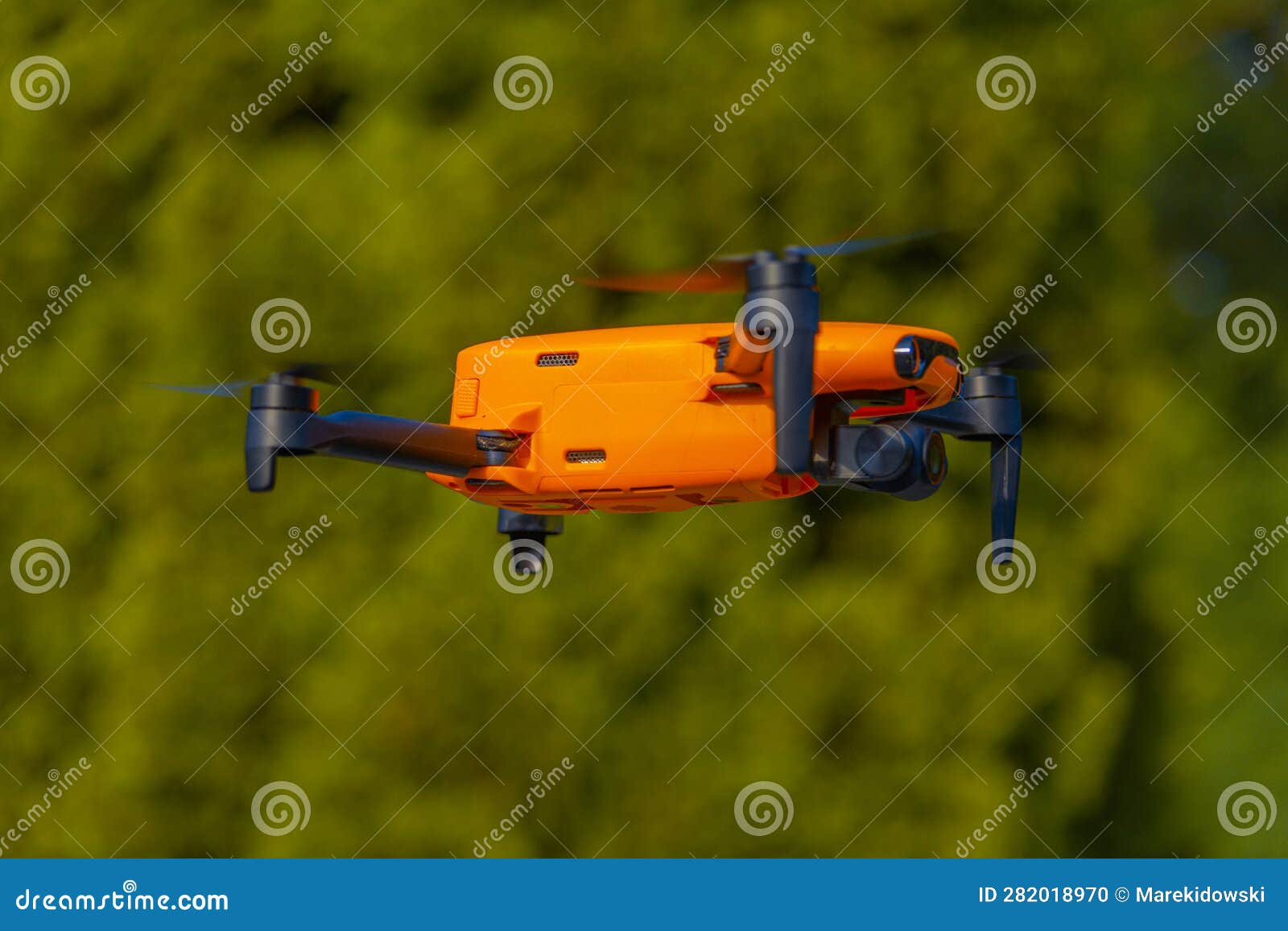 An Orange, Four-engined Drone in Flight. Stock Photo - Image of digital ...