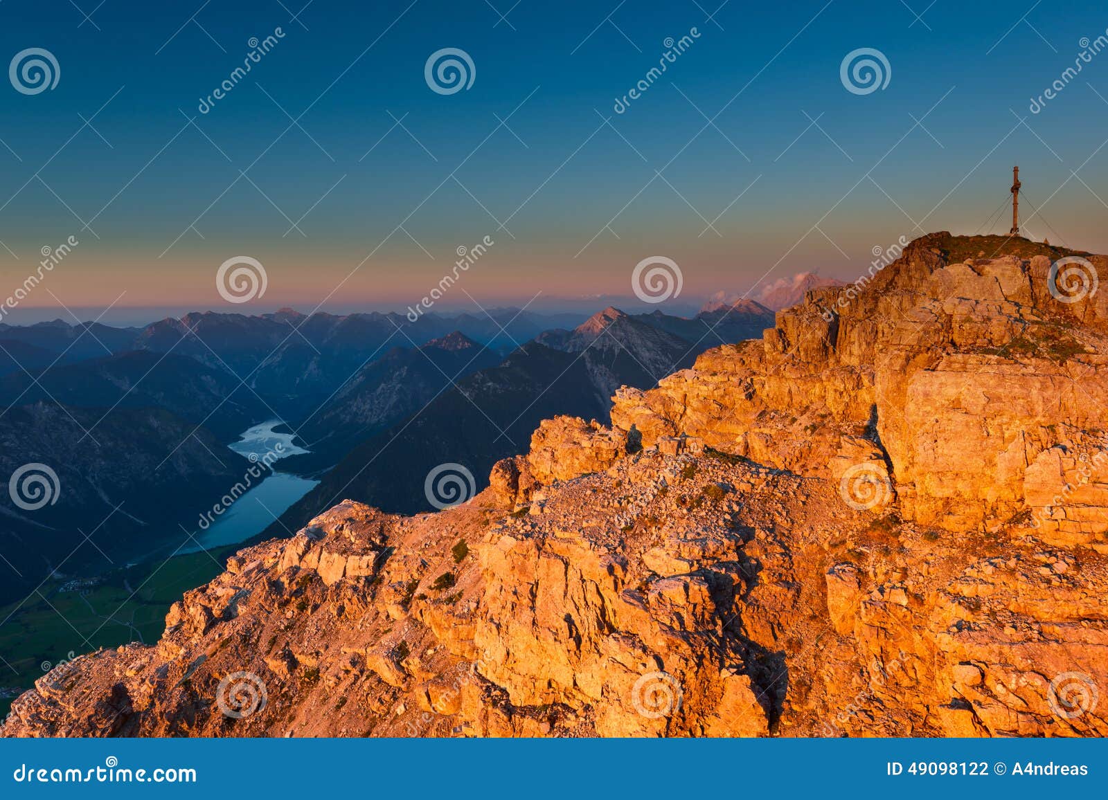 Orange Glowing Rocks of Mountain Peak with Cross Stock Photo - Image of ...