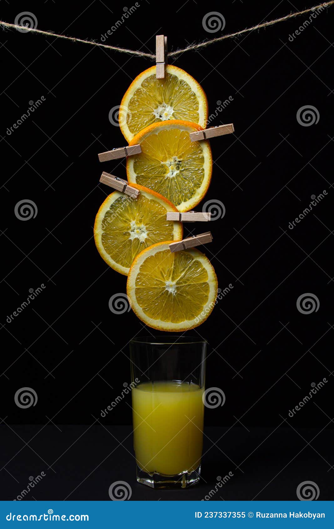 Orange and Orange Juice on a Black Background. Orange Slices on a Rope ...